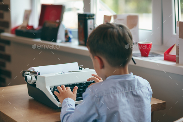 Boy with typewriter Stock Photo by diignat | PhotoDune