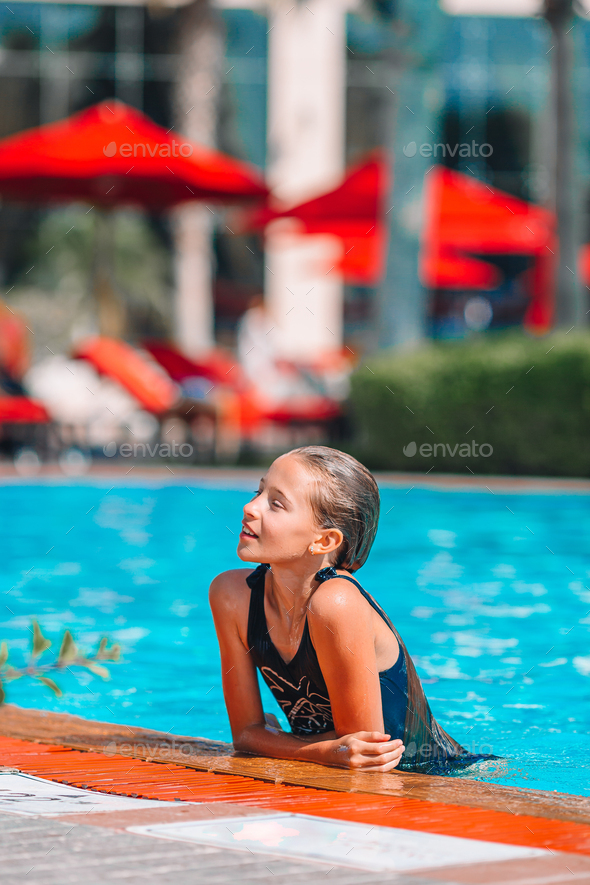 Little adorable girl in outdoor swimming pool Stock Photo by ...