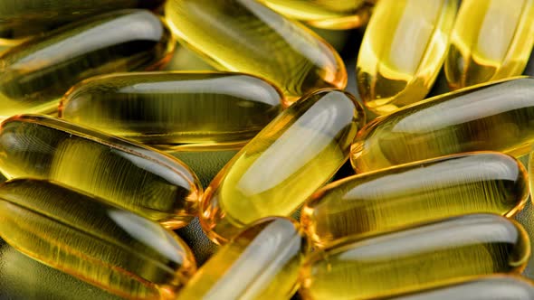 Transparent Yellow Pills with Liquid Inside Slowly Turning Fullframe ...