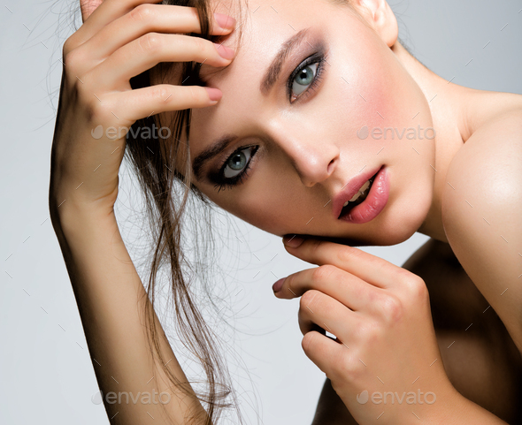 Portrait of a beautiful girl with a long curl of hair hanging down on ...