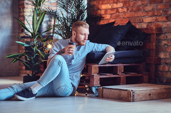 The full body image of blond stylish male using a tablet PC. Stock ...