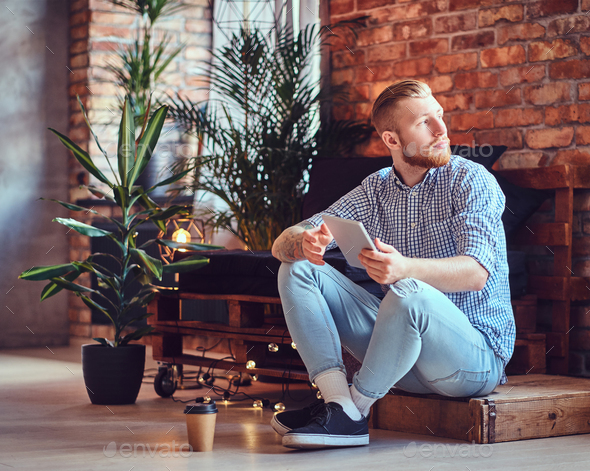 The full body image of blond stylish male using a tablet PC. Stock ...