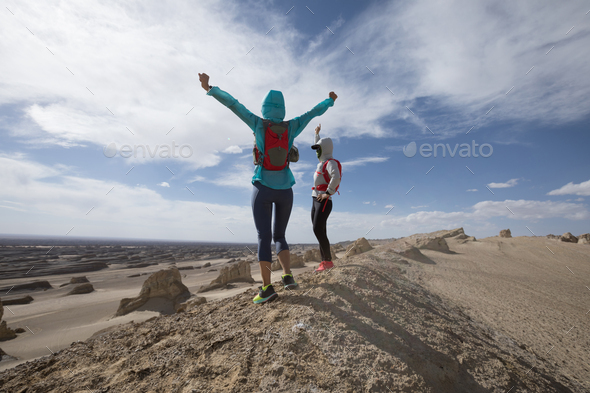 RunningTwo women trail runners cross country running on sand desert ...