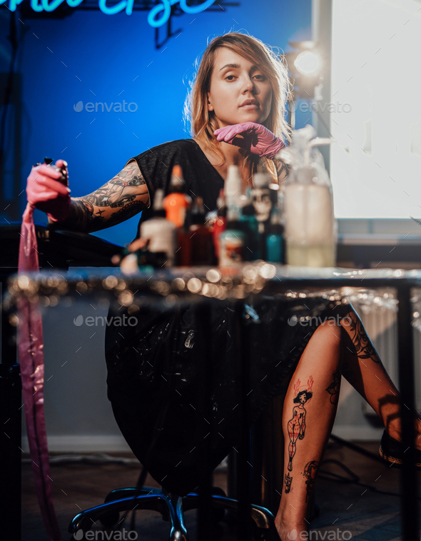 Tattoo master sitting on chair and posing in her small salon Stock ...