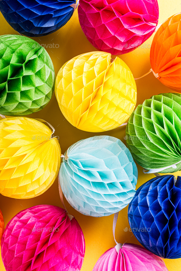 Festive background with colorful paper balls. Stock Photo by Merinka