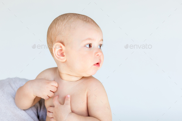 side view of mother holding adorable baby boy isolated on white, 1 year ...