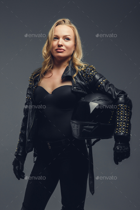 Portrait of blond female in motorcycle uniform. Stock Photo by fxquadro