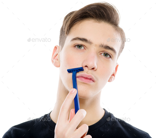 Teenage boy is shaving at first time his mustaches with a razor. Stock ...