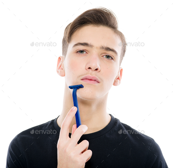 Teenage boy is shaving at first time his mustaches with a razor. Stock ...