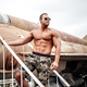 Bodybuilder from USA looking away with old airplane behind Stock Photo ...