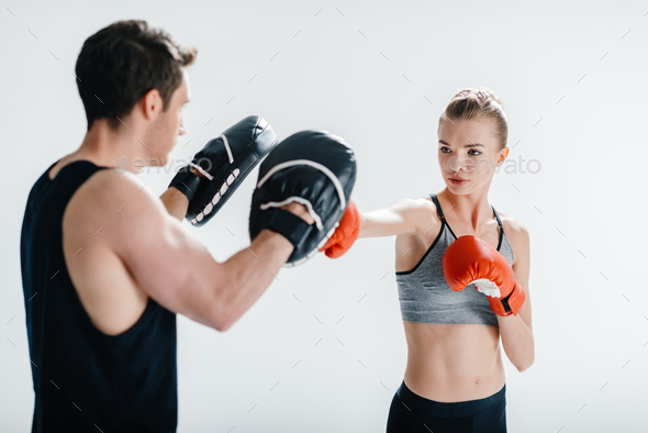 beautiful young girl boxing with trainer isolated on white Stock Photo ...