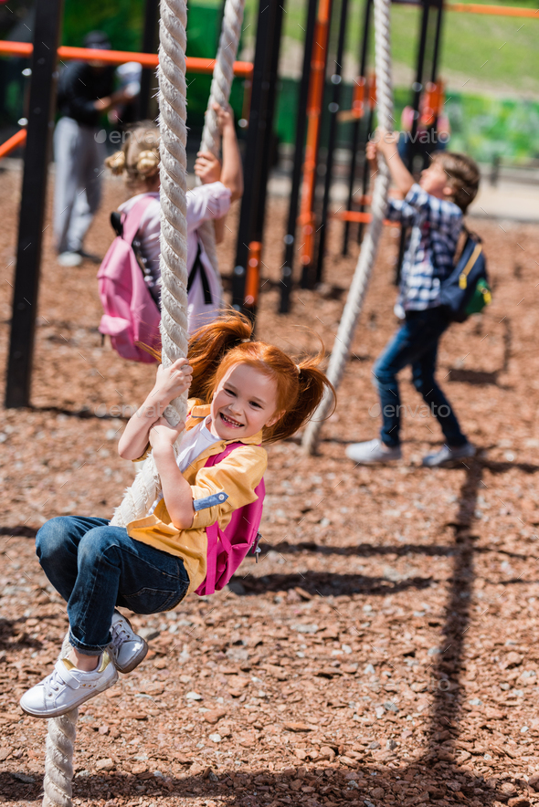 adorable little schoolkids playing with ropes on playground Stock Photo ...