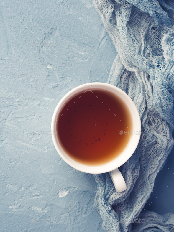 Cup of tea on blue background with flowers Stock Photo by tenkende