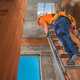 Contractor on a Ladder Inside Newly Constructed Building Stock Photo by ...