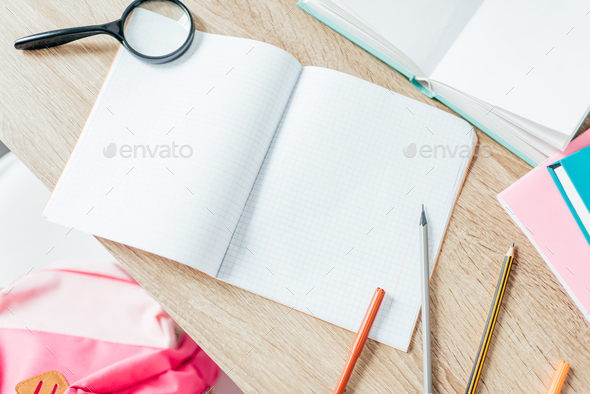 Writing desk with school supplies and open notebook placed on it. Stock ...