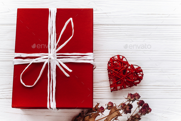 stylish red present top view on white rustic wooden background Stock ...