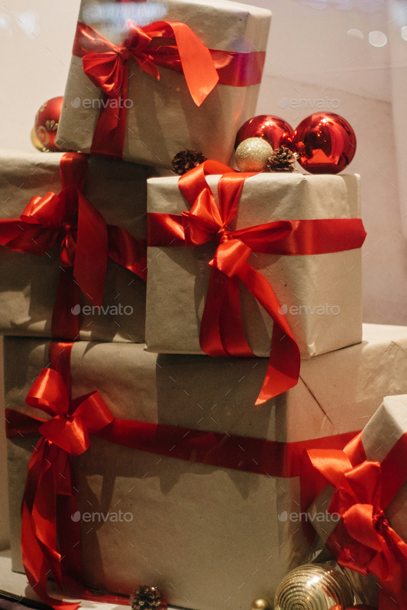 stylish craft gift boxes with red ribbons in window shop, seasonal ...