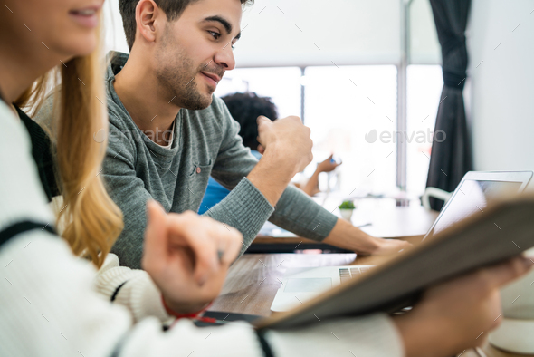 Creative designers working in a project together. Stock Photo by megostudio