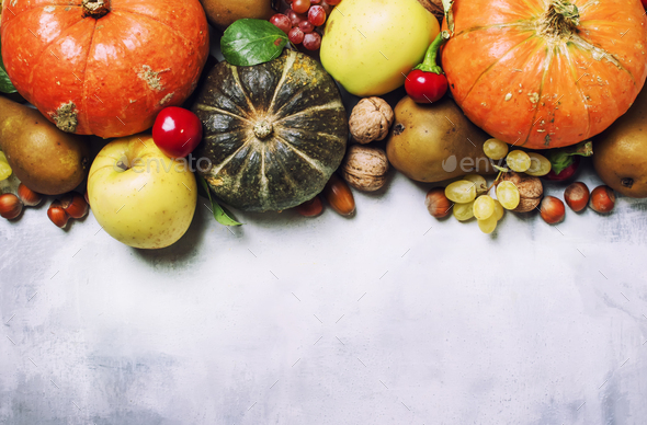 Autumn food background with pumpkins, vegetables, fruits and nuts ...
