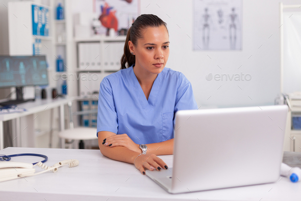 Medical nurse working on laptop Stock Photo by DC_Studio | PhotoDune