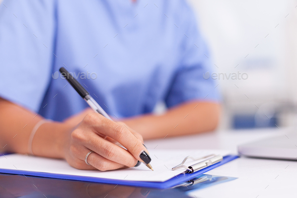 Close up of nurse taking notes on Stock Photo by DC_Studio | PhotoDune