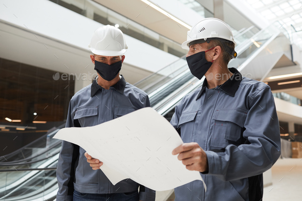 Construction Workers Wearing Masks Stock Photo by seventyfourimages