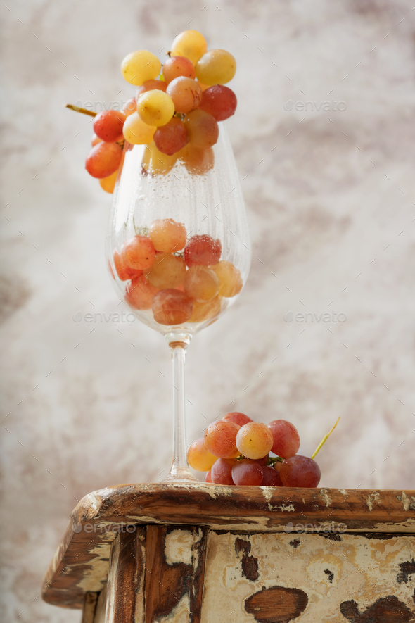 Bunch of pink grapes over rustic background Stock Photo by SebastianaRaw