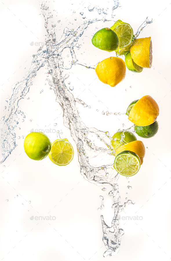 Fresh limes and lemons with water splash in midair, isolated on white ...