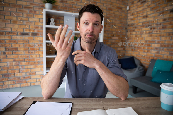 Portrait of man making hand gestures while sitting on his desk Stock ...