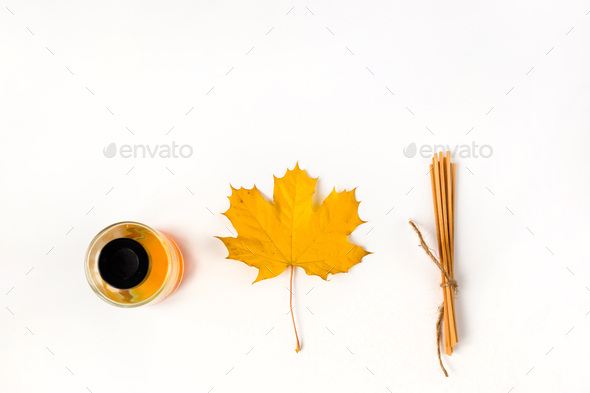 Perfume jar, colorful maple leaves. White table background Stock Photo ...