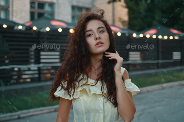 Beautiful female face with lights in background Stock Photo by diignat