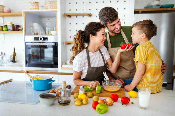 Happy family in the kitchen having fun and cooking together Stock Photo ...