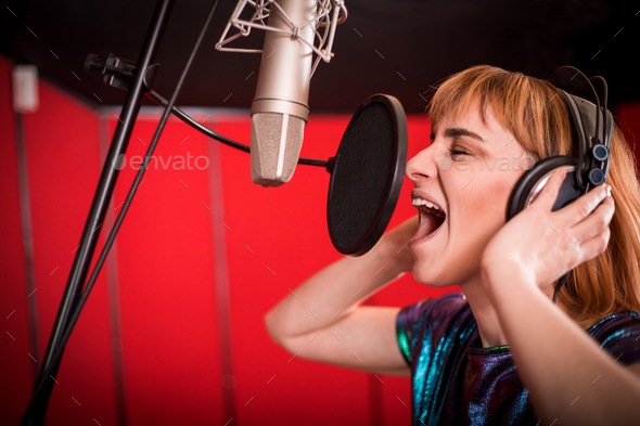 Pretty female singer recording voice in sound studio Stock Photo by ...