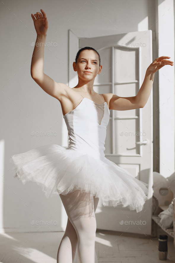 Ballerina posing in front of white background Stock Photo by prostooleh
