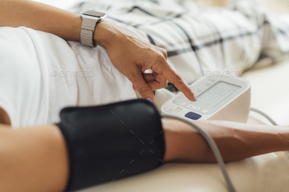 Measuring Orthostatic Blood Pressure at Home. Stock Photo by microgen