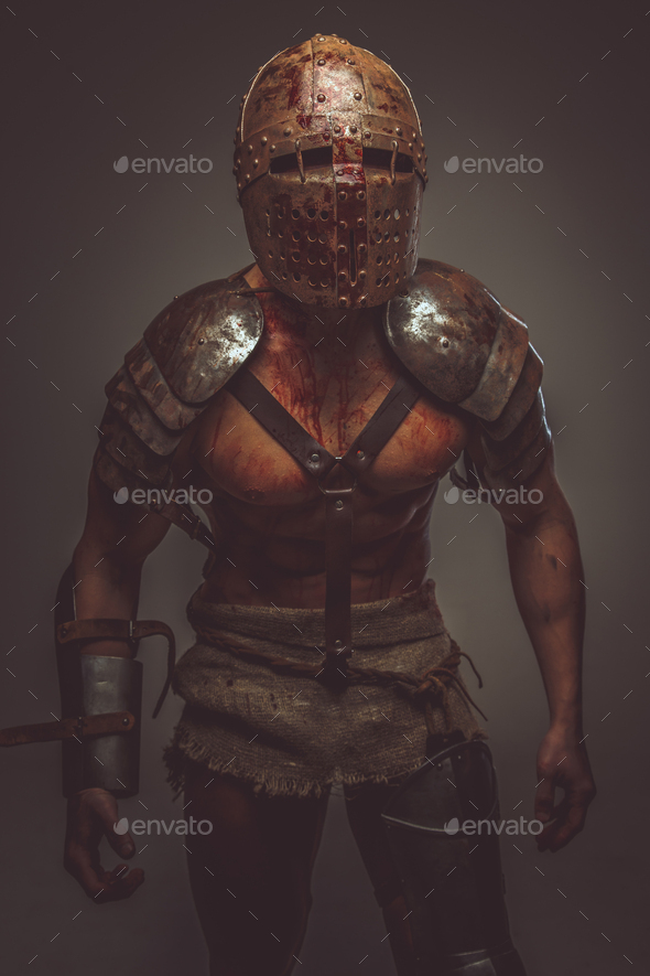 Bloody gladiator in armor and helmet. Stock Photo by fxquadro | PhotoDune