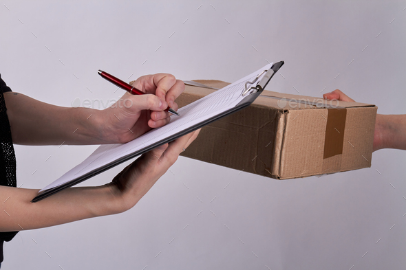 Detailed view of a customer signing delivery note. Stock Photo by ...