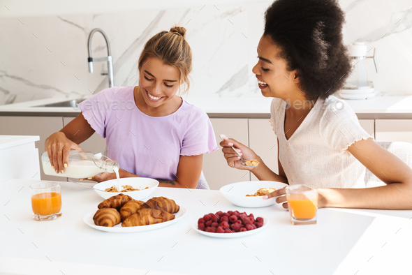 Beautiful multicultural girls smiling while doing makeup together Stock ...
