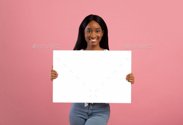 Beautiful African American lady with blank banner on pink studio ...