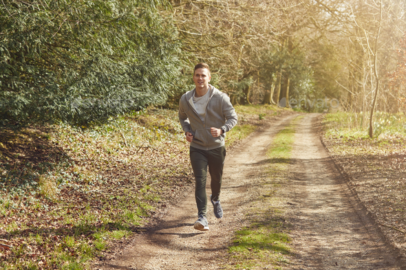 Smiling Man Running In Autumn Countryside Exercising During Covid 19 ...