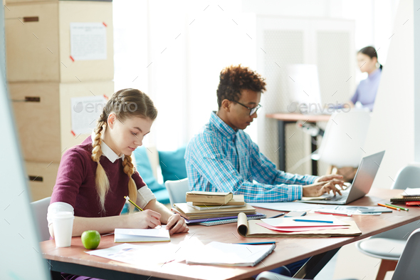 Work in library Stock Photo by Pressmaster | PhotoDune