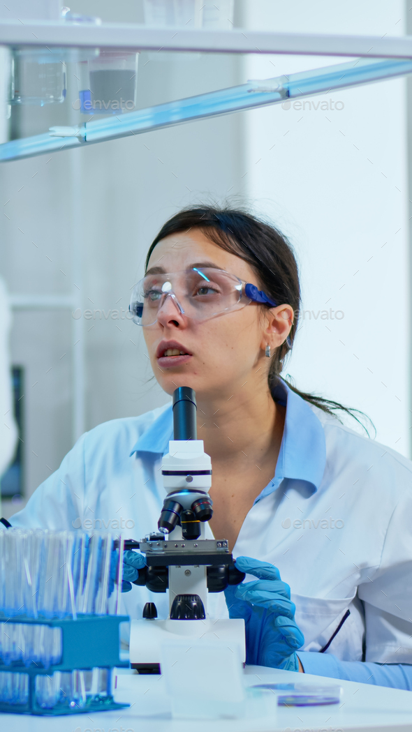 Team medical scientist conducting DNA experiments under digital ...