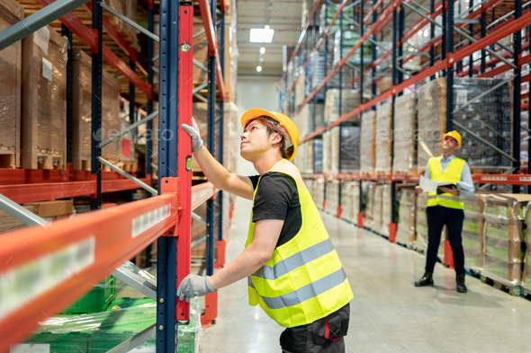 Worker during rack arrangement erection work in warehouse Stock Photo ...