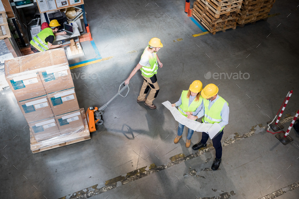 Group of warehouse workers at work, above view Stock Photo by leszekglasner