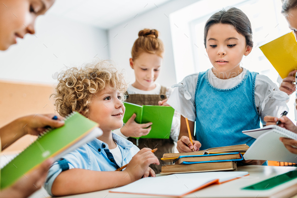 schoolchildren writing off homework of their classmate during break ...