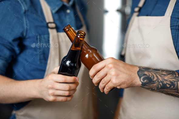 Male brewery worker tasting beer, standing in plant Stock Photo by ...