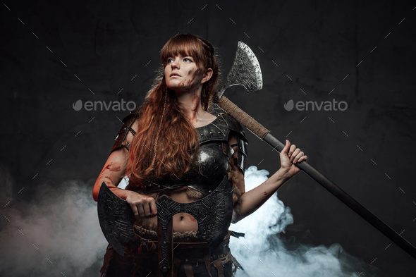 Scandinavian female conqueror armed with axes Stock Photo by fxquadro
