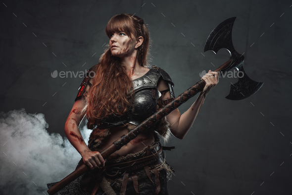 Holding two handed axe northern female warrior in dark background Stock ...