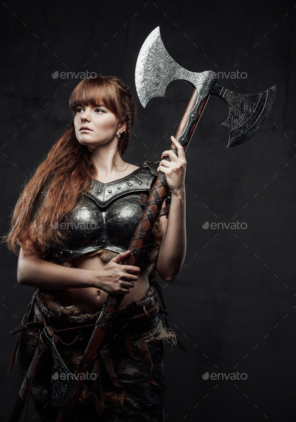 Dangerous northern woman armed with two handed axe Stock Photo by fxquadro