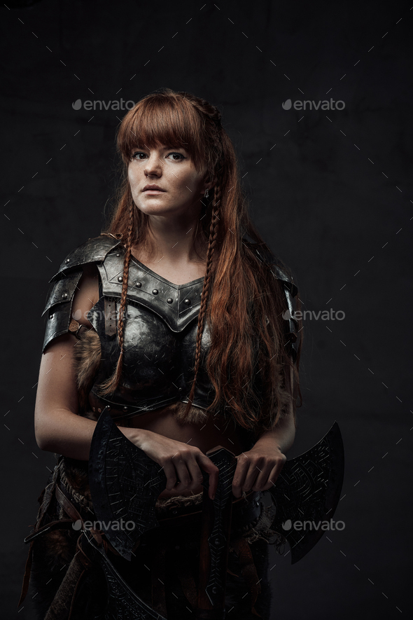 Beautiful woman viking with two handed axe in dark background Stock ...